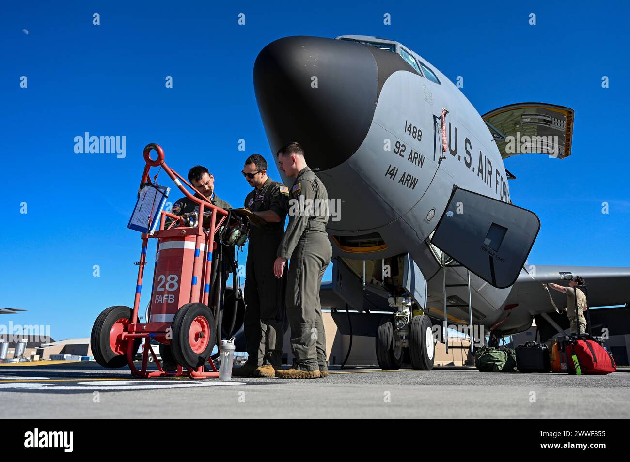 Airmen assigned to the 92nd Air Refueling Wing conduct a pre-flight ...