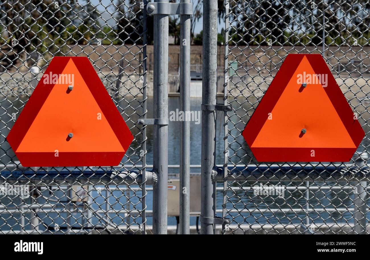 warning triangles on cyclone fence at a Alameda County Water District ...