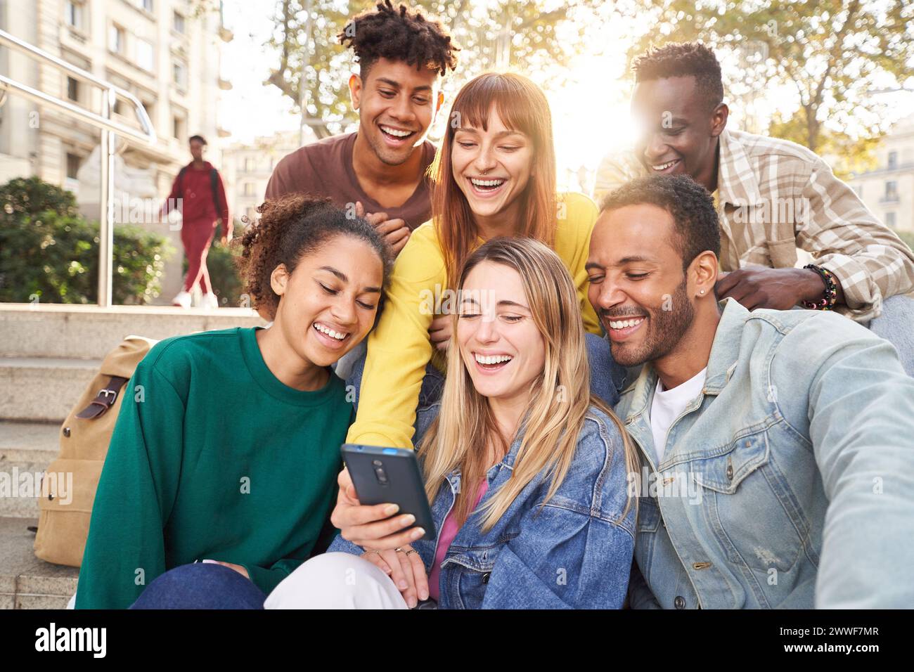 Diverse group university friends sitting on stairs in street city ...
