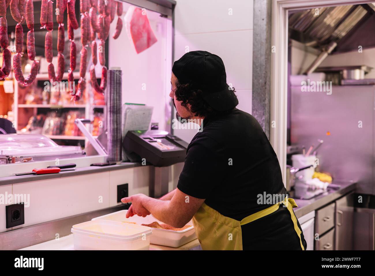 butcher is seen peering outside of his shop, scanning for potential ...