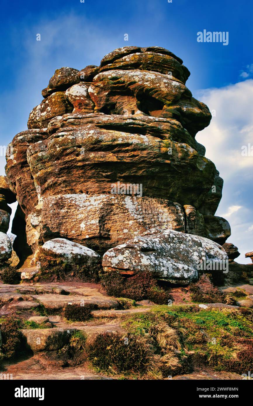 Majestic rock formation under blue sky with clouds, showcasing natural ...