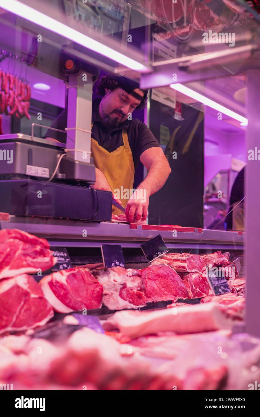vertical portrait A low angle shot of a butcher in an apron seen ...