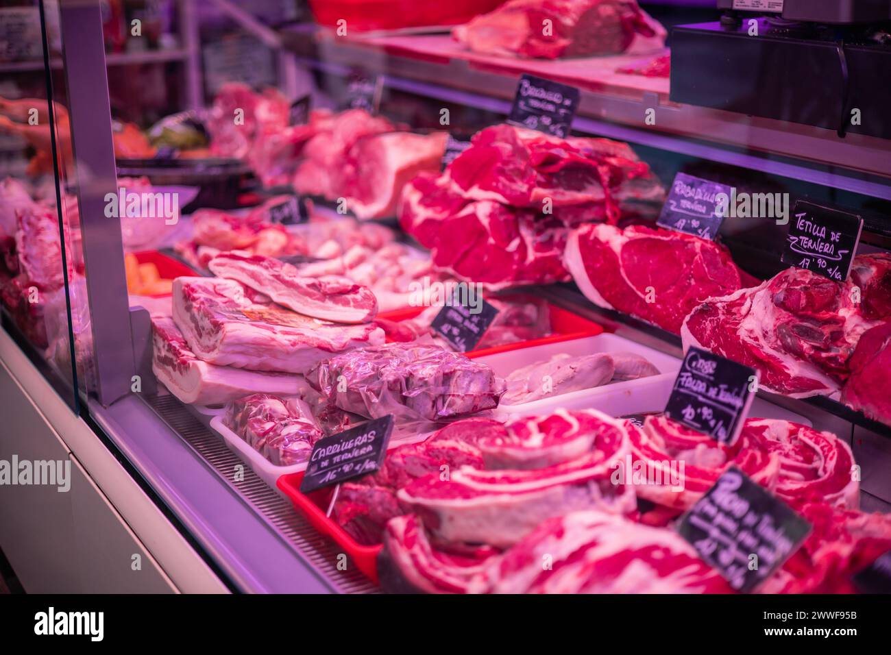 This closeup image showcases a variety of fresh meats displayed on the ...
