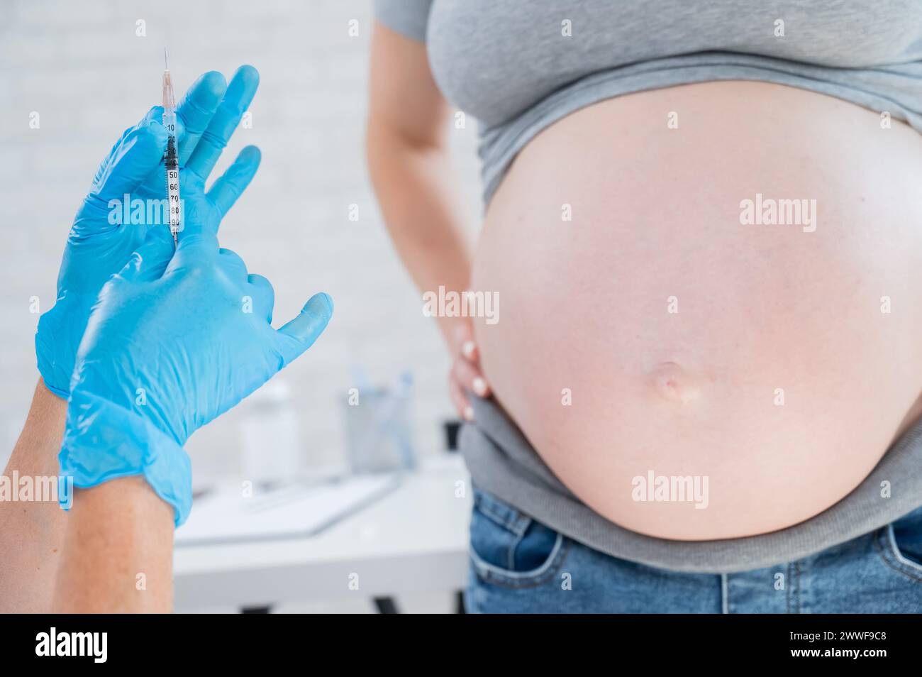 Doctor gives an injection in the stomach of a pregnant woman Stock ...