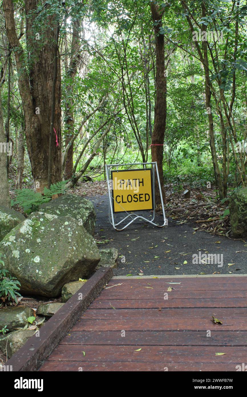 Forest of trees with a "path closed" sign Stock Photo - Alamy