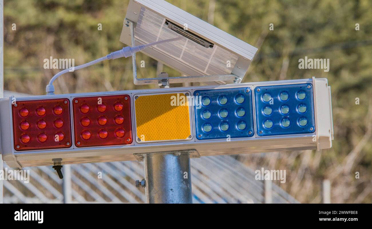 Traffic lights with LED panels in red, amber, and blue mounted on a ...