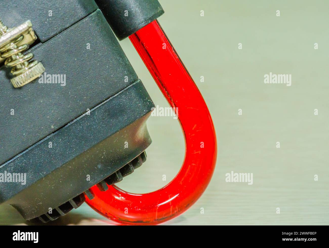 A red plastic VGA connector clip on a green background, in South Korea ...