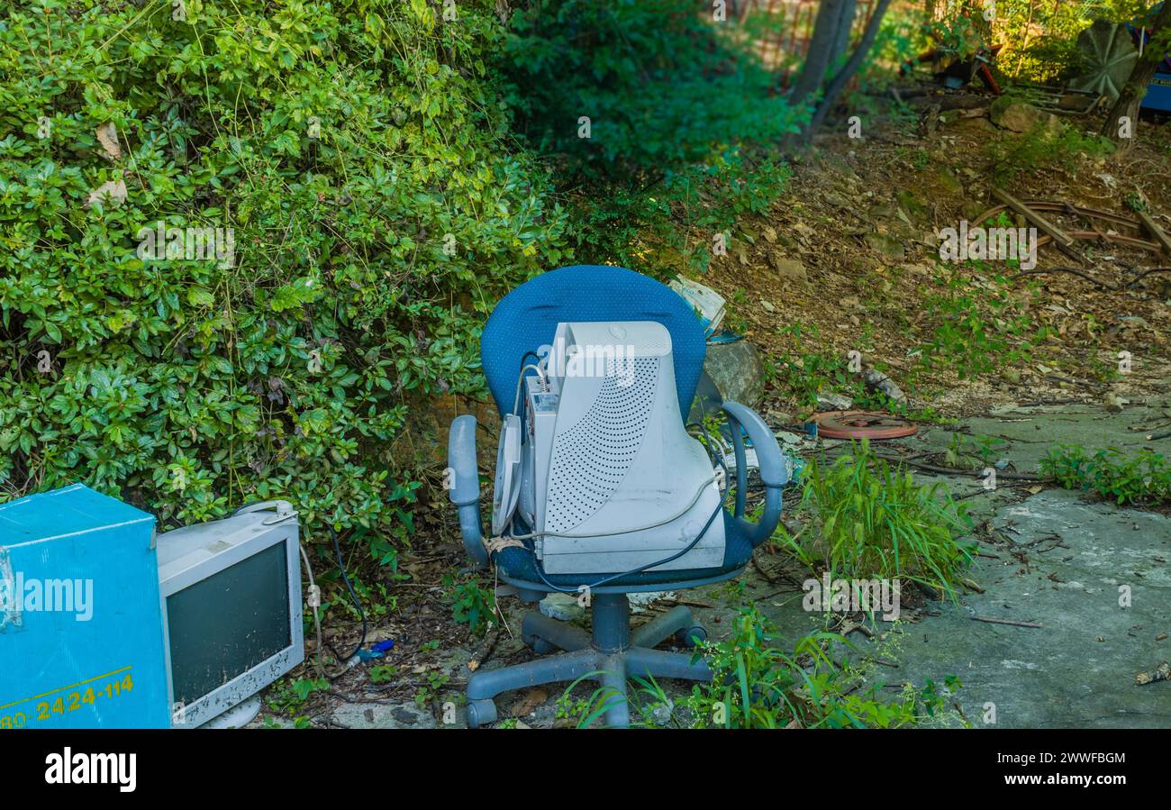 Old CRT computer monitors discarded in rural wooded area. One in old ...