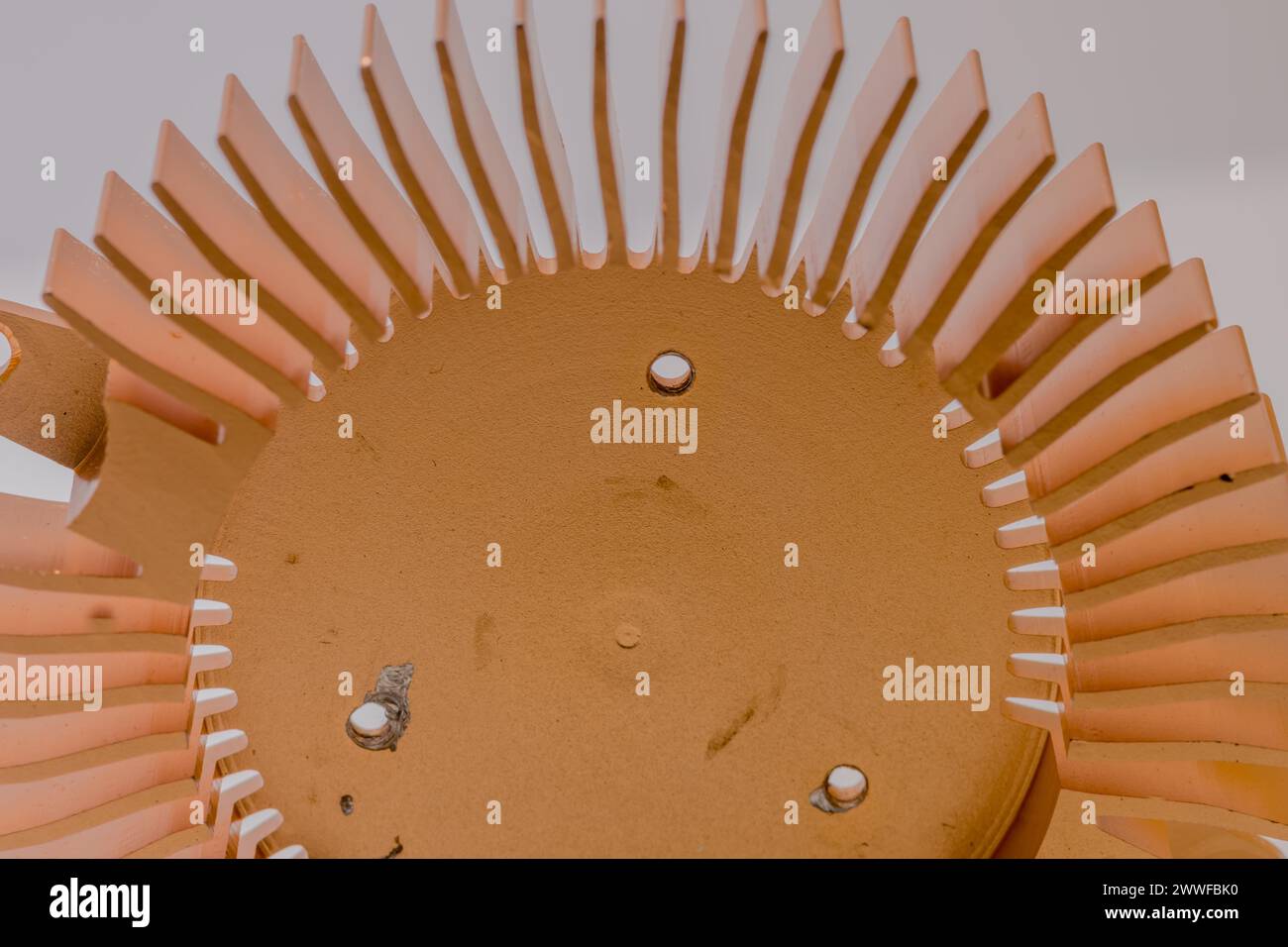 Closeup of copper heat sink fins and fan mounting surface with chipped ...