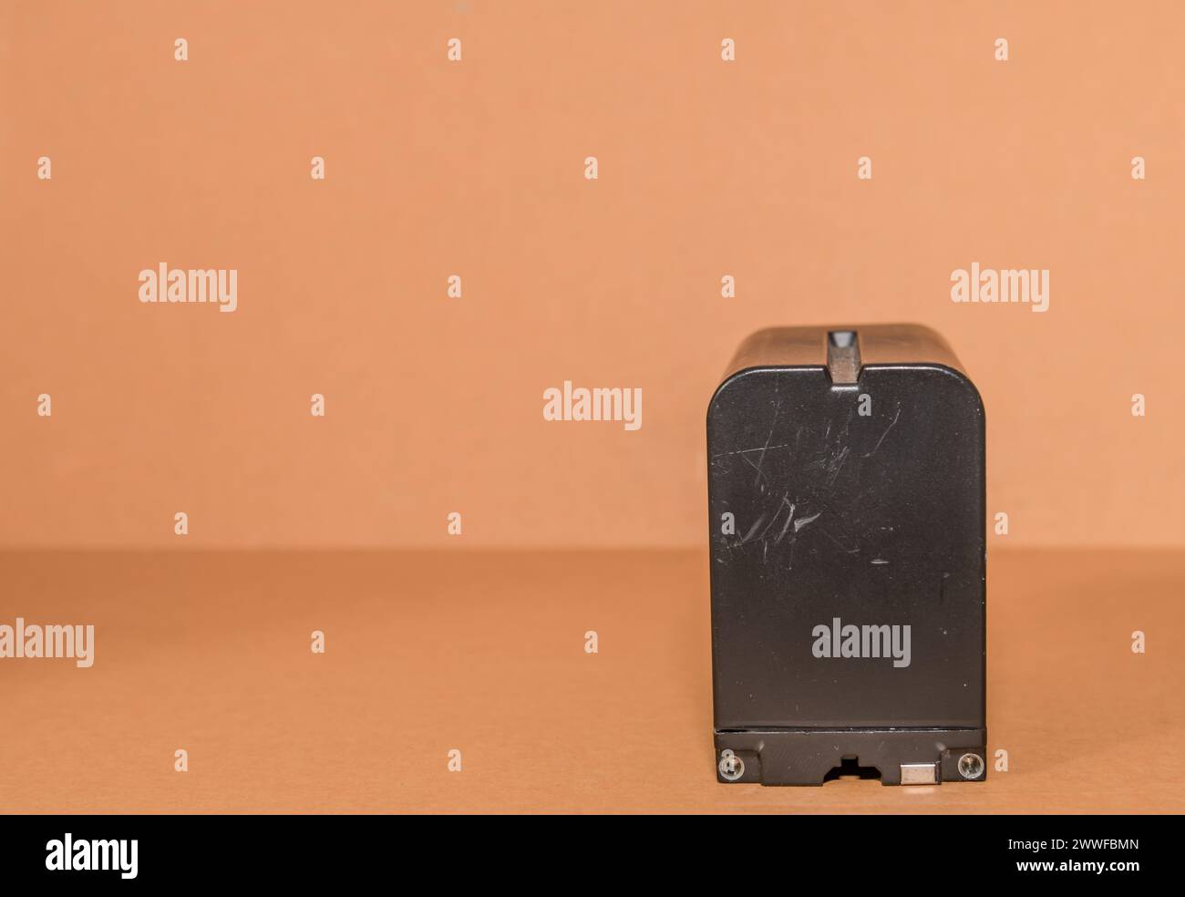 Closeup side view of used Lithium-ion battery on brown background Stock ...