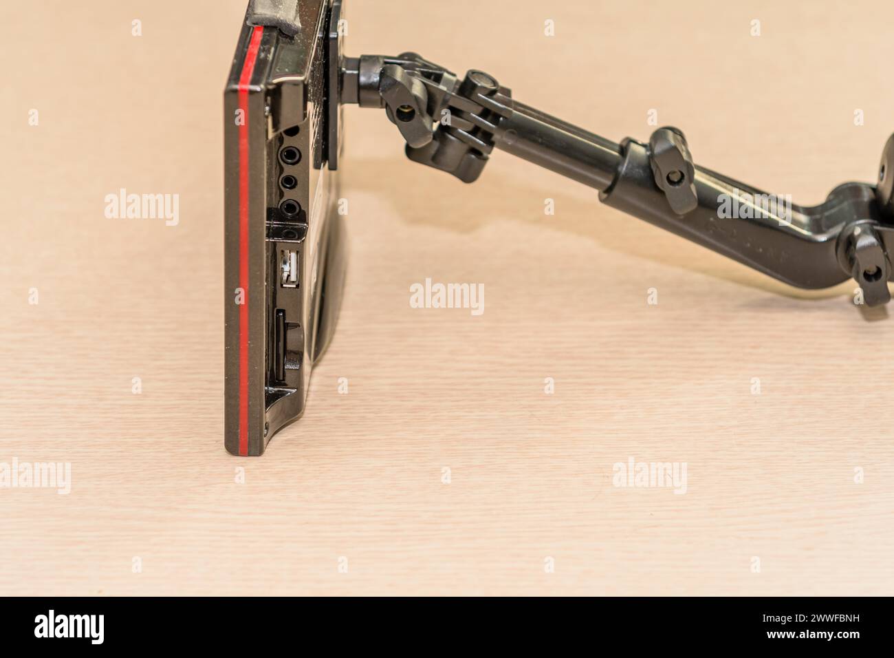 Side view of automobile navigation system with attached mounting arm ...