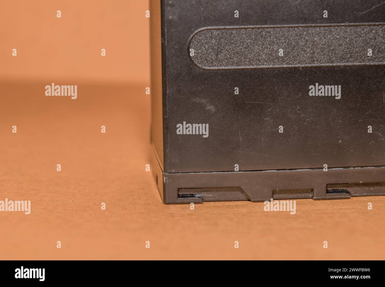 Closeup side view of used Lithium-ion battery on brown background ...