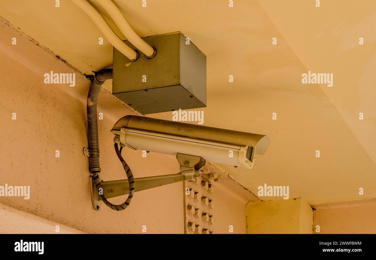 Security camera mounted on side of a wall of a concrete structure in ...