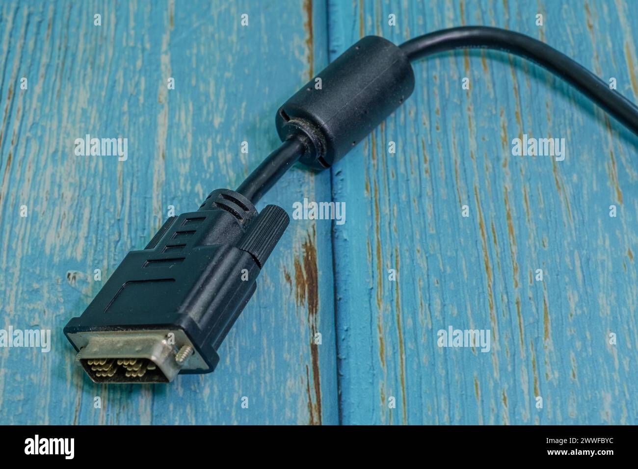 Black DVI-D monitor cable isolated on blue wood grain background Stock ...