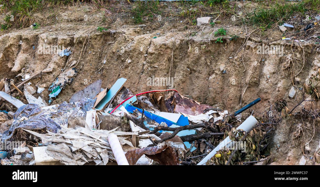 Debris from construction materials scattered at a site of soil erosion ...