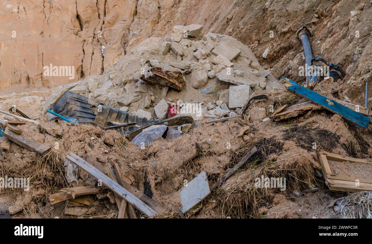 Construction waste with pipes and bricks on disturbed soil, in South ...