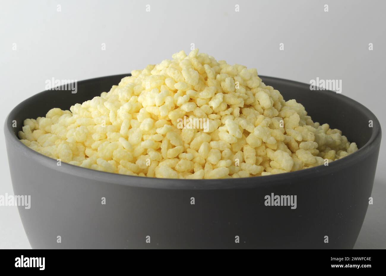 Puffed rice cereal in a grey bowl on a white background Stock Photo - Alamy