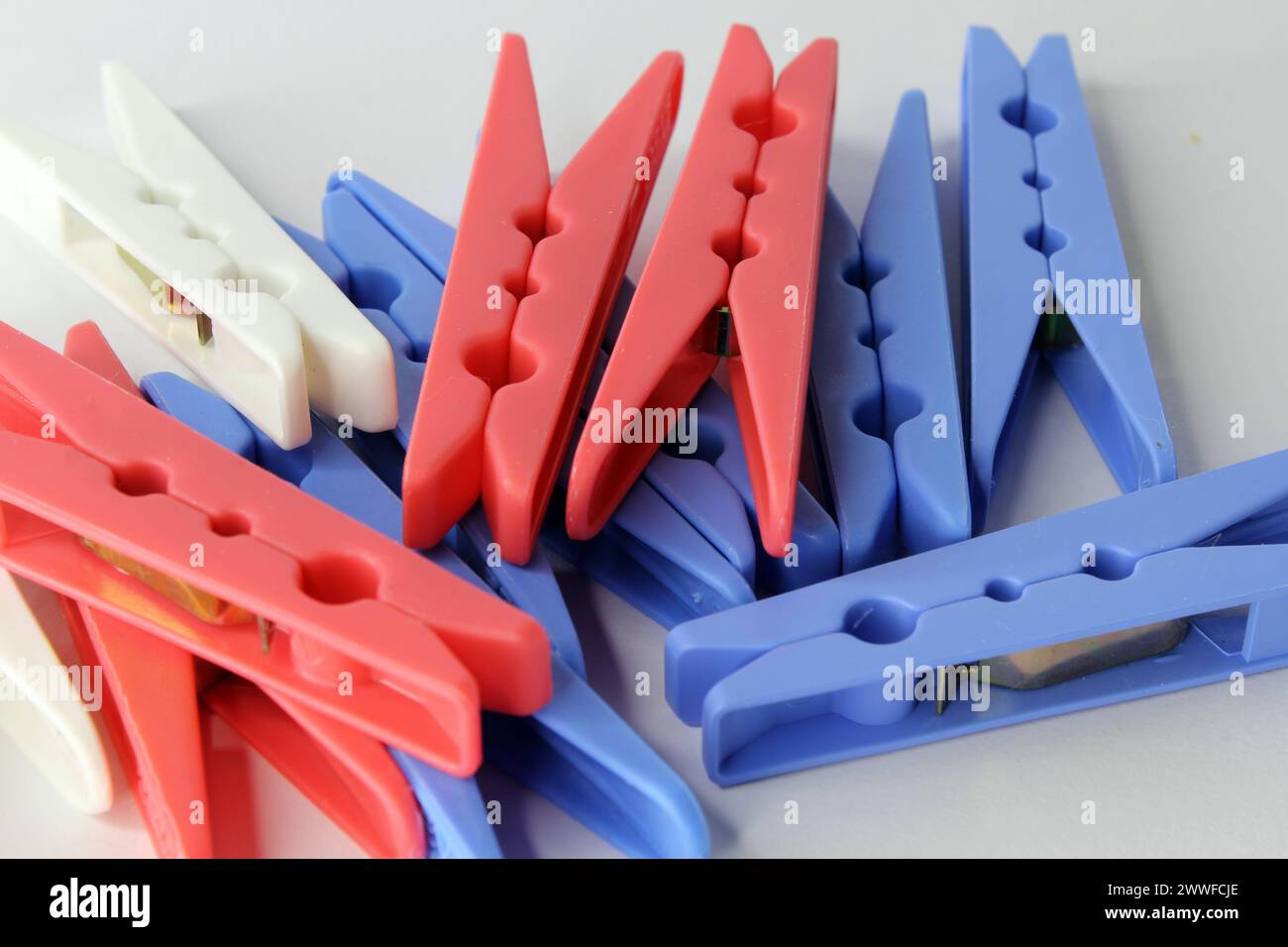 Pink, blue and white clothes pegs against a white background Stock ...