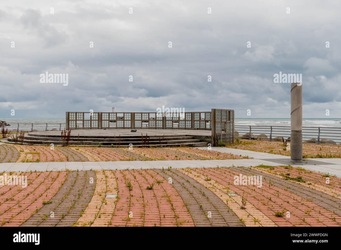 Empty viewing platform facing the sea with a wide-open space under a ...