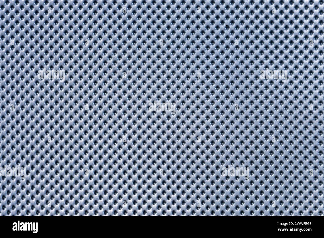 Details of repeated patterns of perforation in the texture of a metal ...