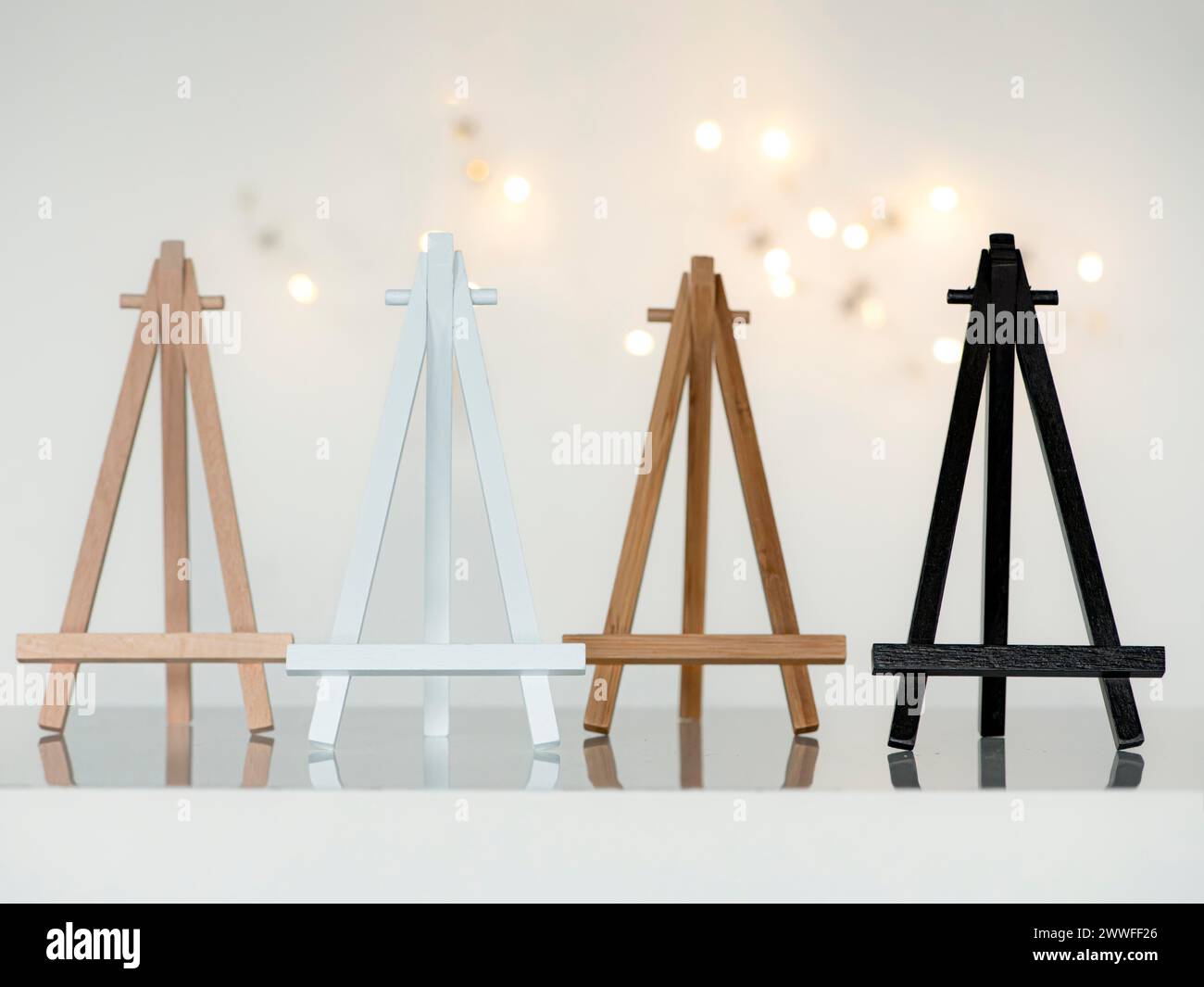 Four small wooden mini easels in the colours beech, white, bamboo and ...