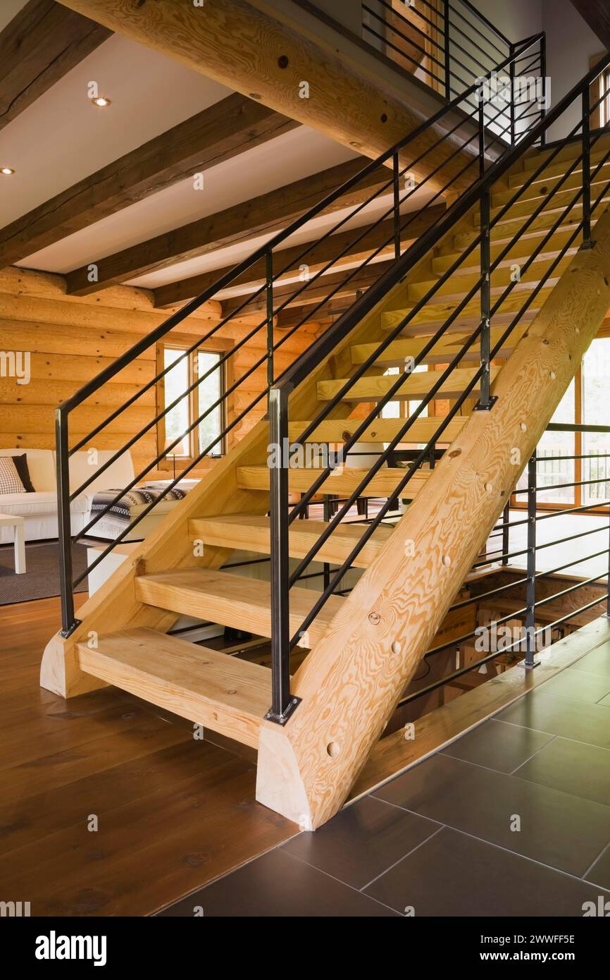 Wooden log stairs with black wrought iron railings and white cotton ...
