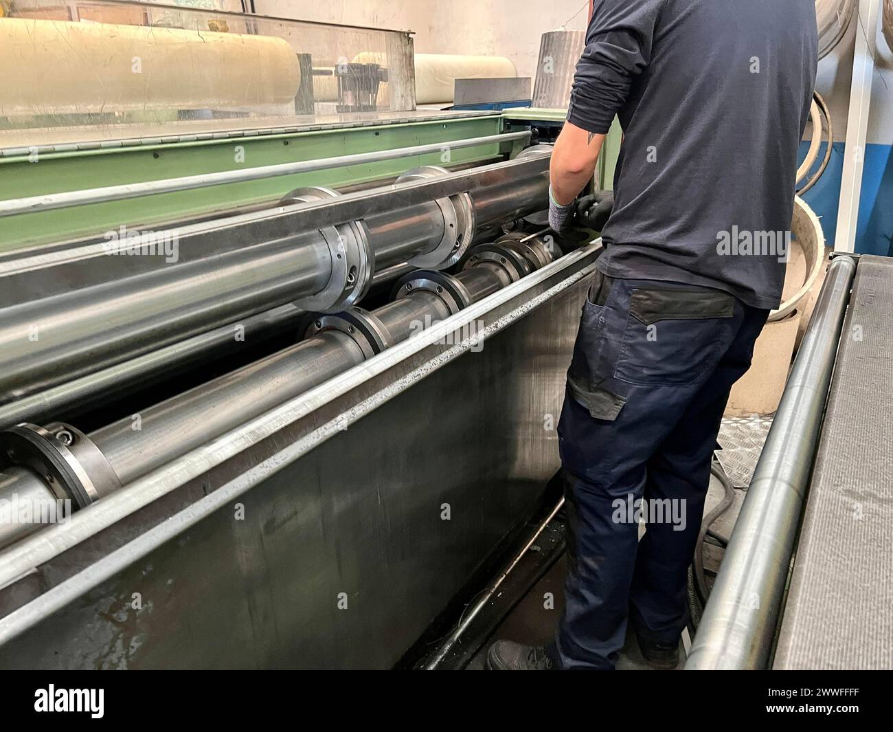Portrait of a man placing the blades for cutting sheet metal on a metal ...