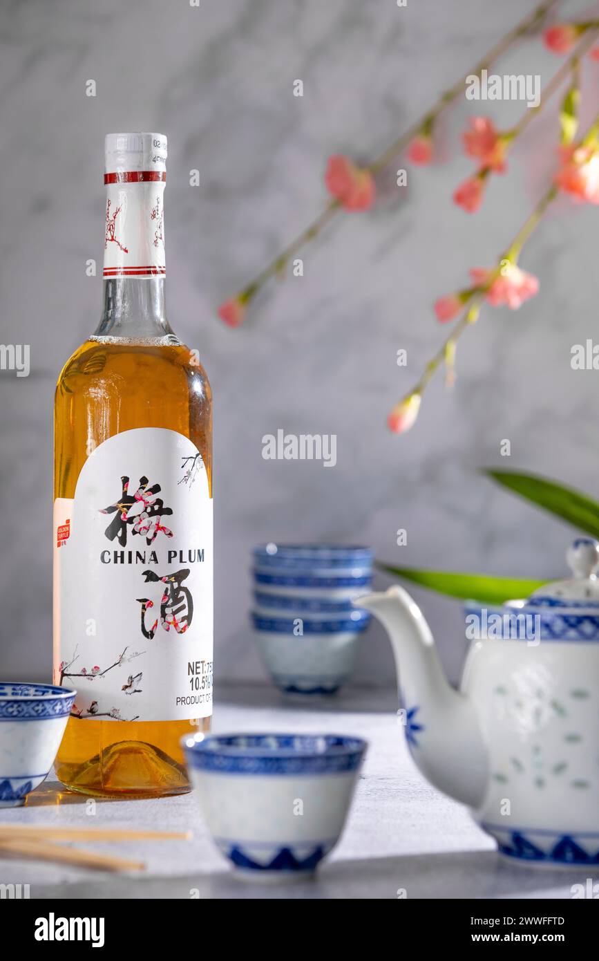 Asian tea set with blue patterns and a bottle of China plum wine Stock ...