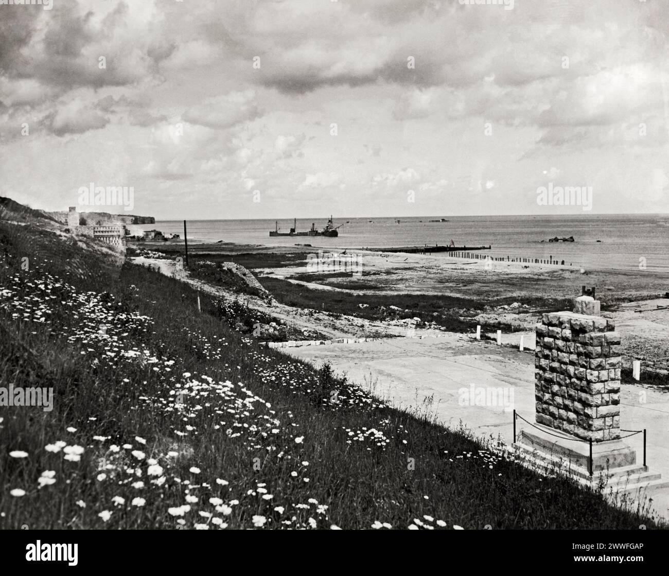 Normandy, France, June 12, 1945 Flowers bloom on the sloping hillside ...