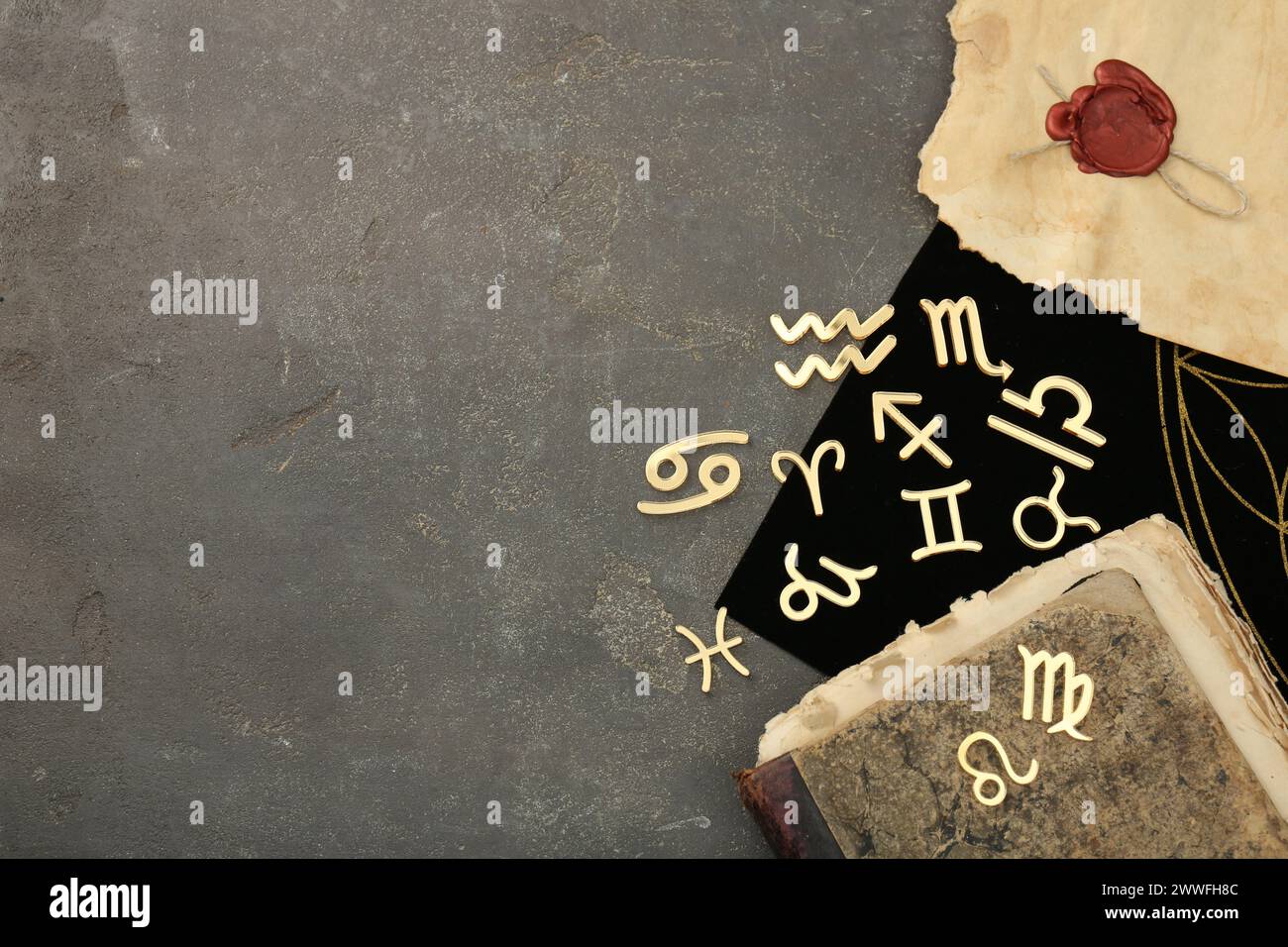 Flat lay composition with zodiac signs on grey textured table. Space ...