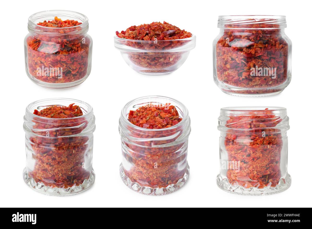 Aromatic spices. Red chili pepper flakes in glass jars and bowl on ...