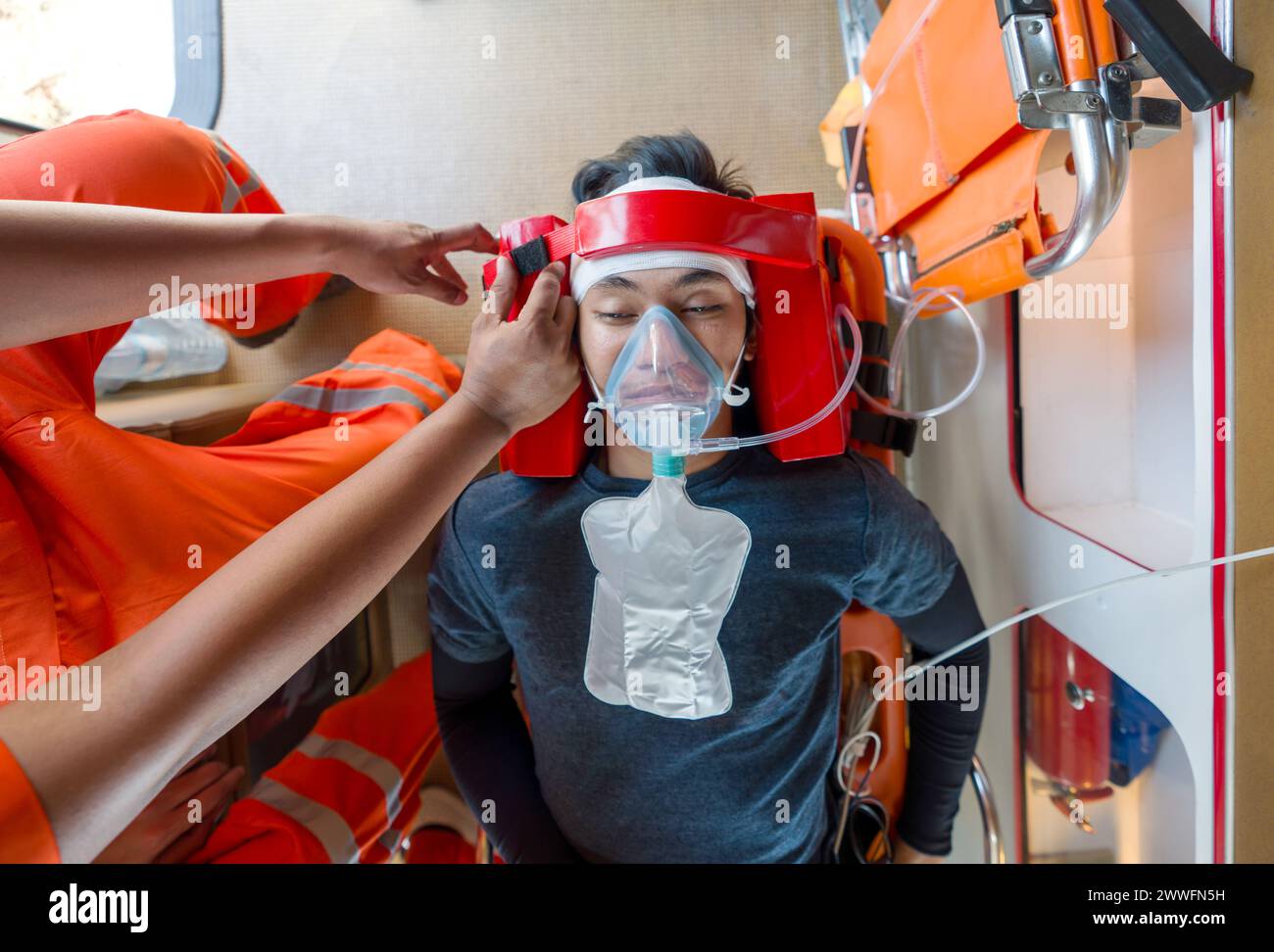 A person is wearing an oxygen mask, getting help from paramedic in ...