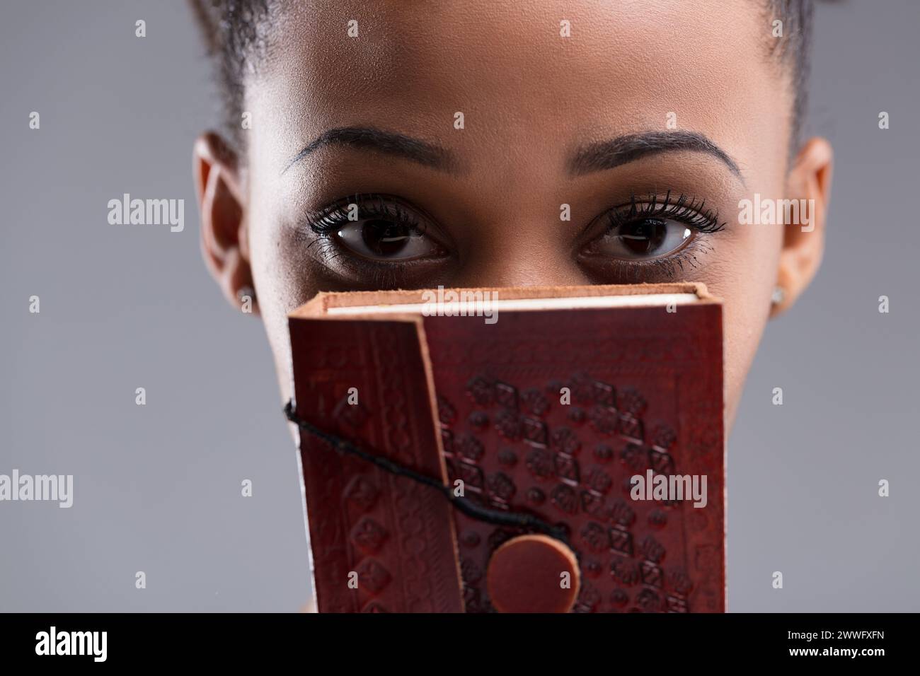 young reader’s eyes tell a tale above the book she’s engrossed in ...