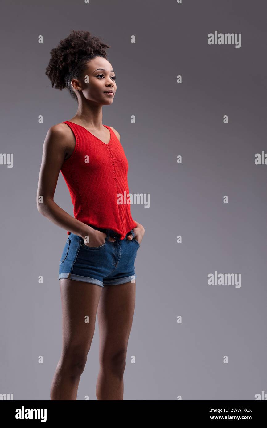 statuesque pose captures the woman's serene confidence, dressed in red ...