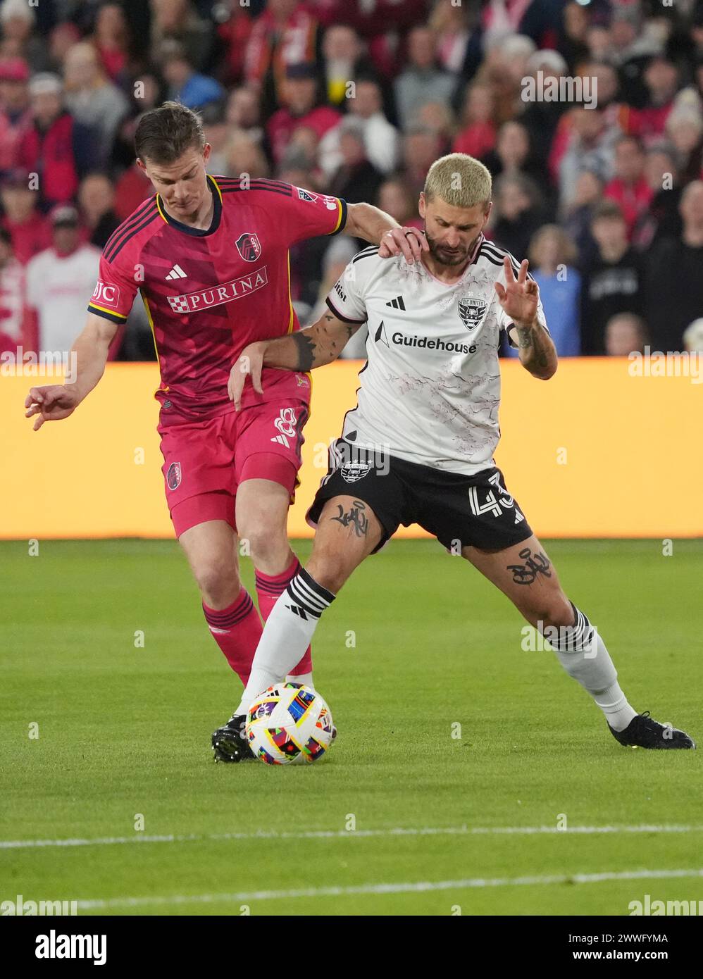 St. Louis, United States. 23rd Mar, 2024. D.C. United Mateusz Klich (R ...