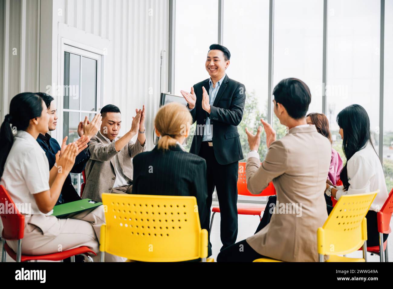 Asian man presents his work in meeting room receiving praise and ...