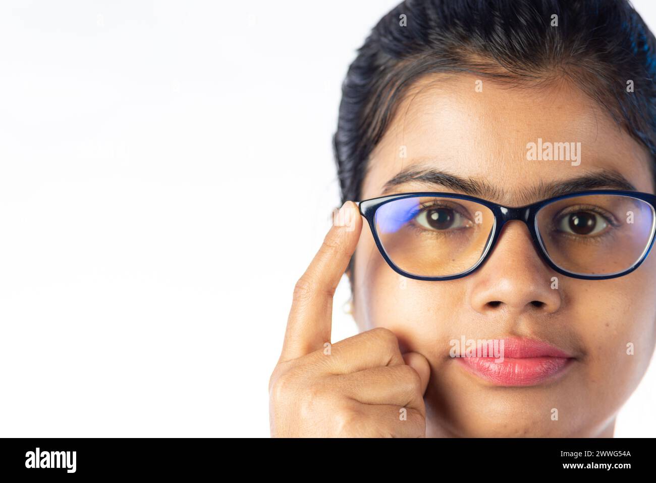 Head shot portrait of a young beautiful Indian female wearing dark ...