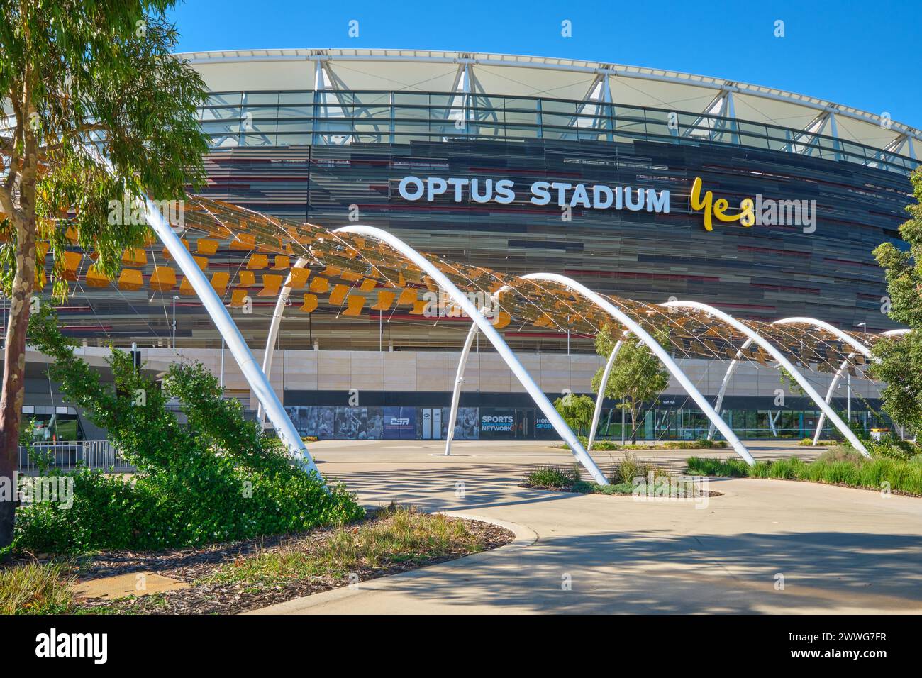 A walkway and plants and trees in front of the multi-purpose venue ...