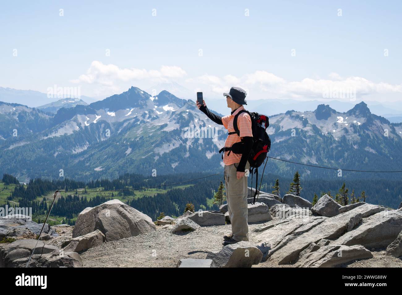 Hiker taking selfie photos using a smartphone at Skyline Trail. Mt ...