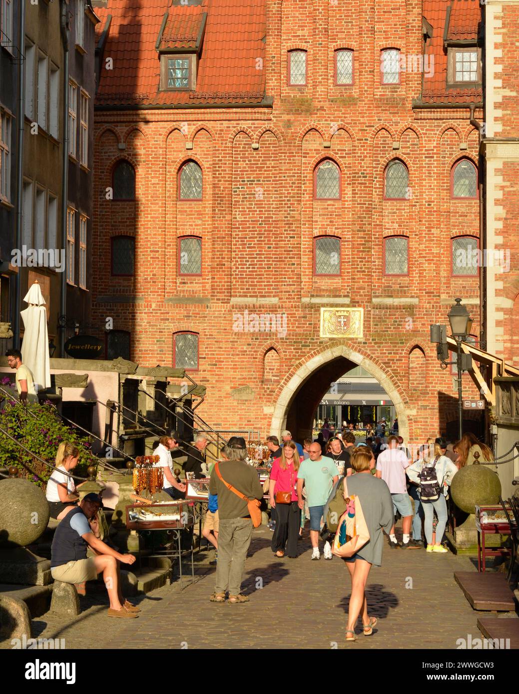 Mariacka Street and tourists at the St. Mary's Gate or Brama Mariacka ...