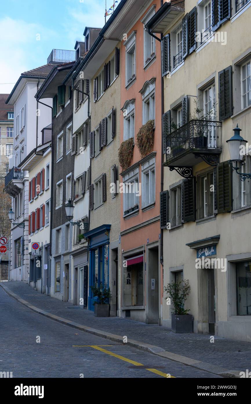 A peaceful street scene with colorful buildings and a cobblestone road ...