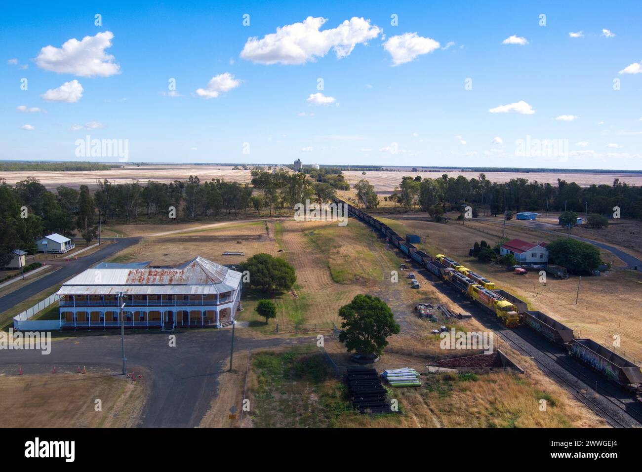 Aerial of Coal Trains passing the historic Warra Hotel one of ...