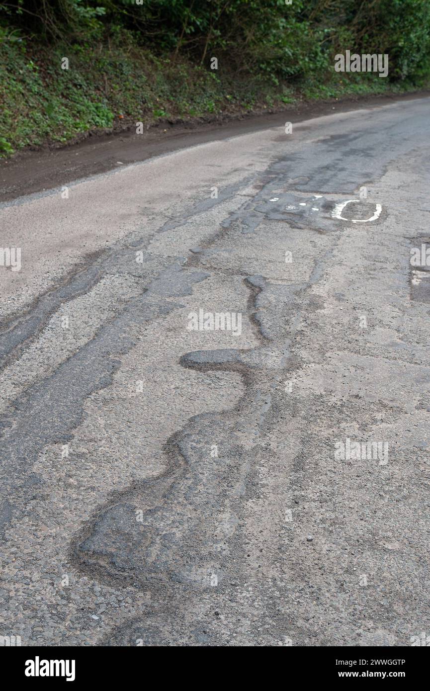 Chesham, UK. 21st March, 2024. A failed road surface on a country road ...