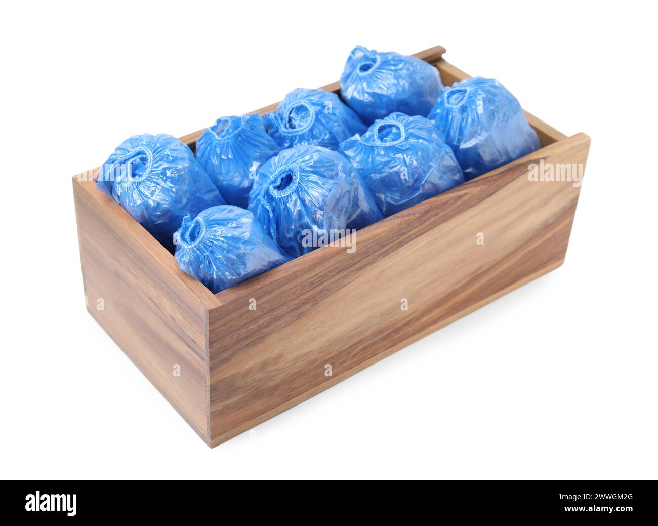 Rolled blue shoe covers in wooden crate isolated on white Stock Photo ...