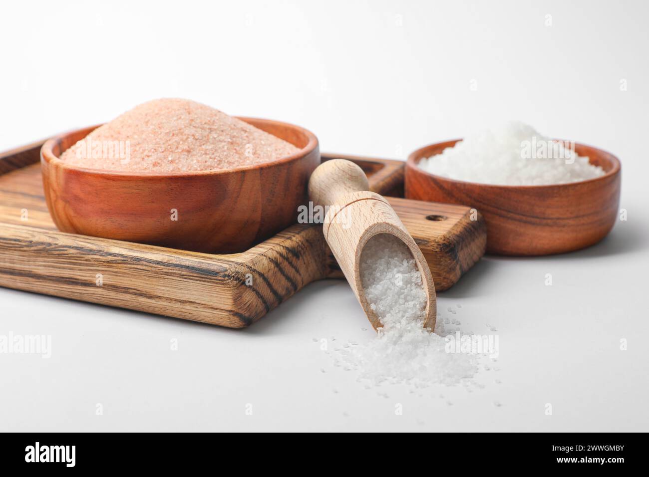 Different types of natural salt on white background Stock Photo - Alamy