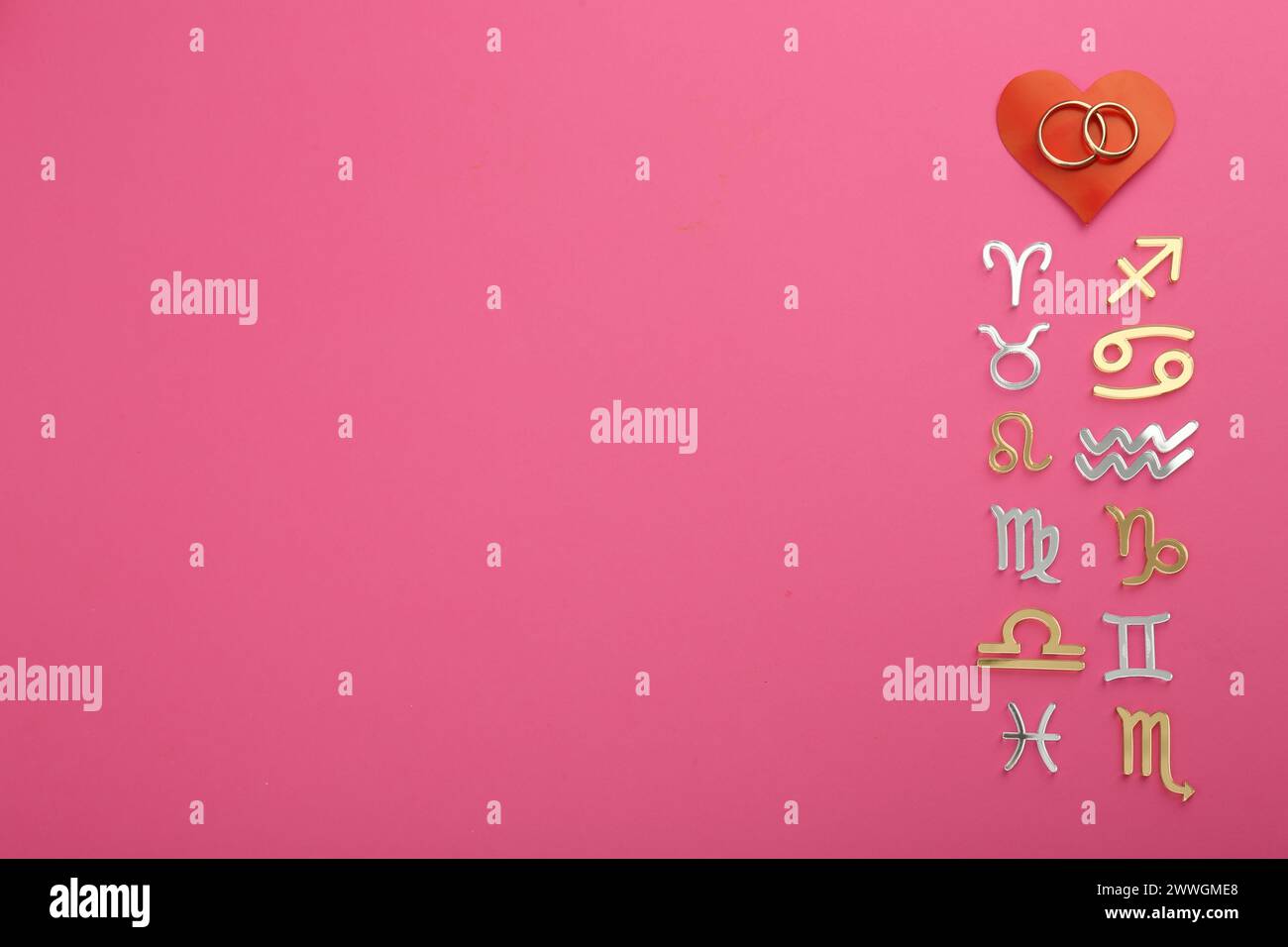 Zodiac compatibility. Signs, wedding rings and red heart on pink ...