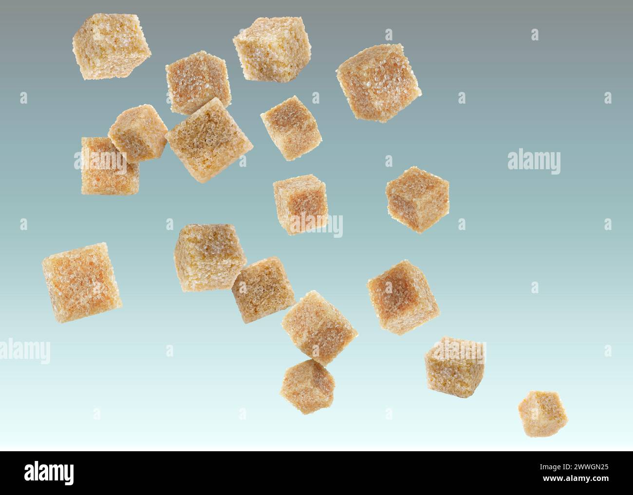 Brown cane sugar cubes falling on color gradient background Stock Photo ...