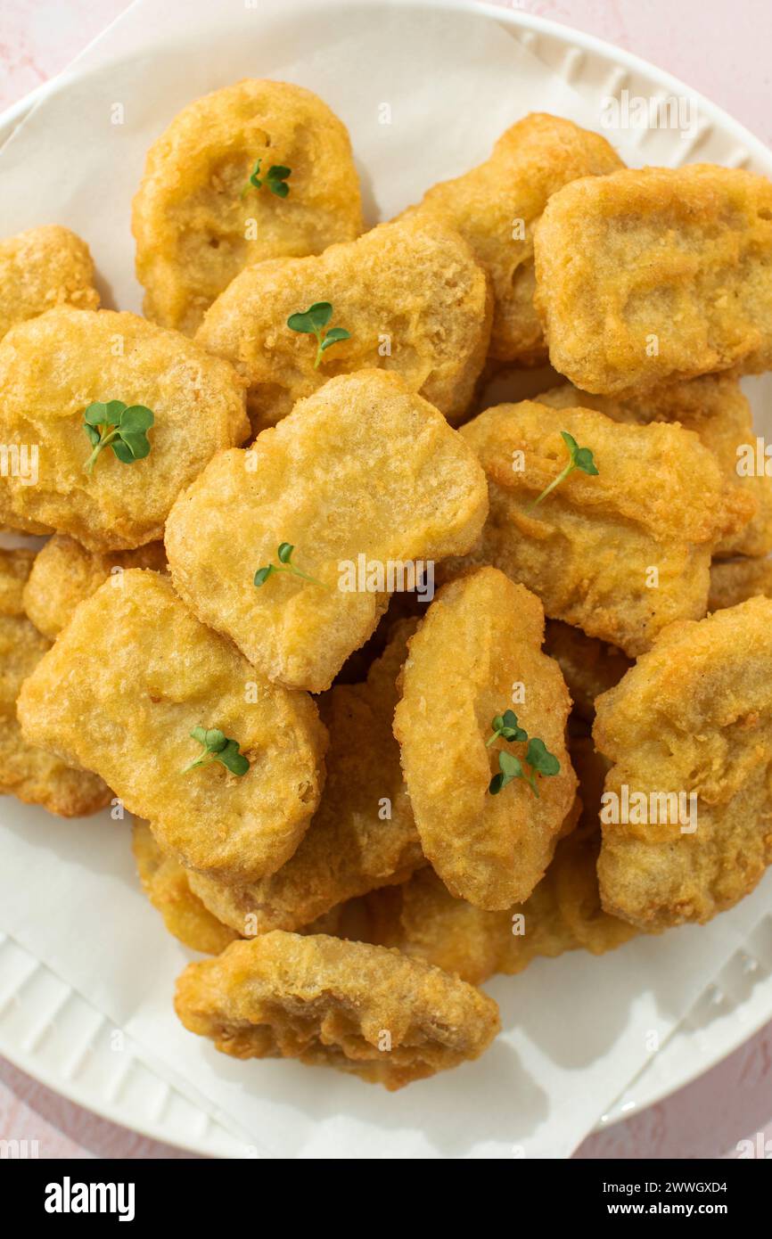 Delicious golden chicken nuggets on a plate close up. Fast food, menu ...