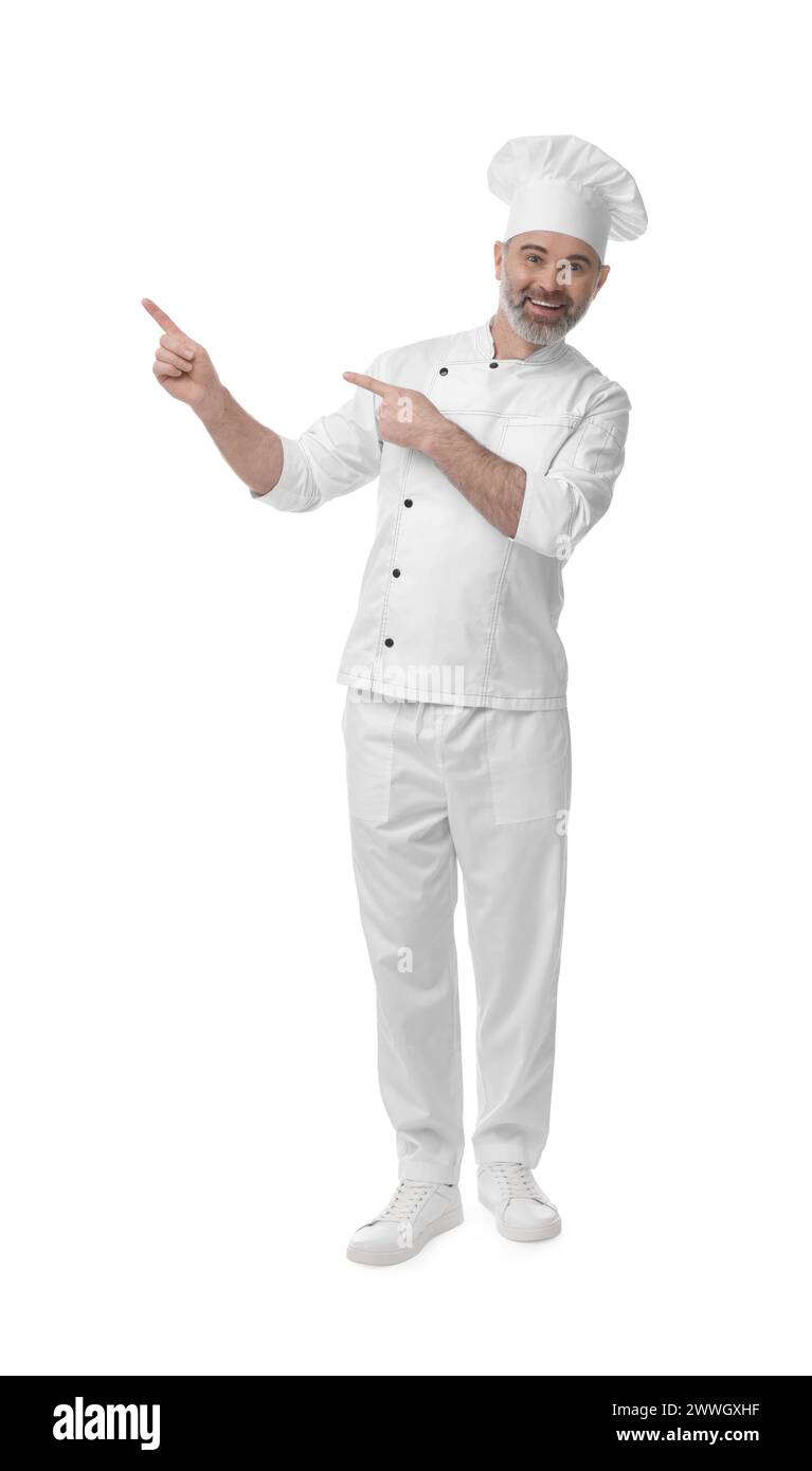 Happy chef in uniform pointing at something on white background Stock ...