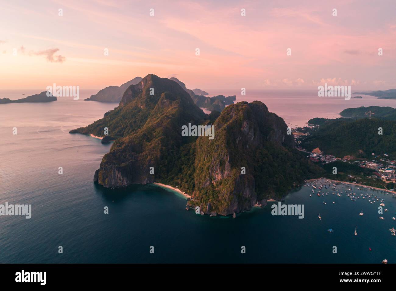 Aerial view of cliffs in the sea, yachts are sailing nearby, mountains ...